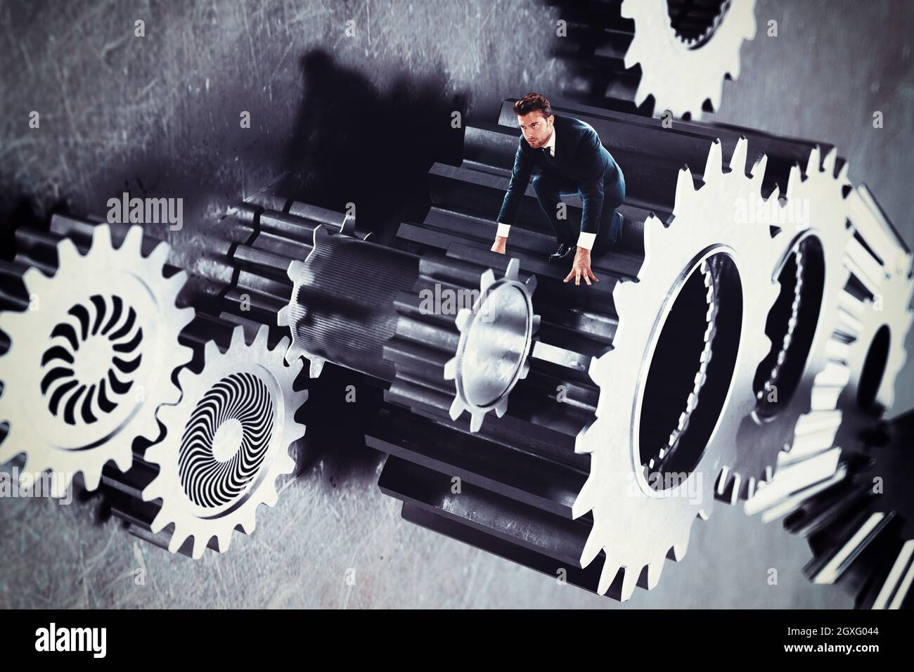 Man in a system of gear stuck Stock Photo - Alamy