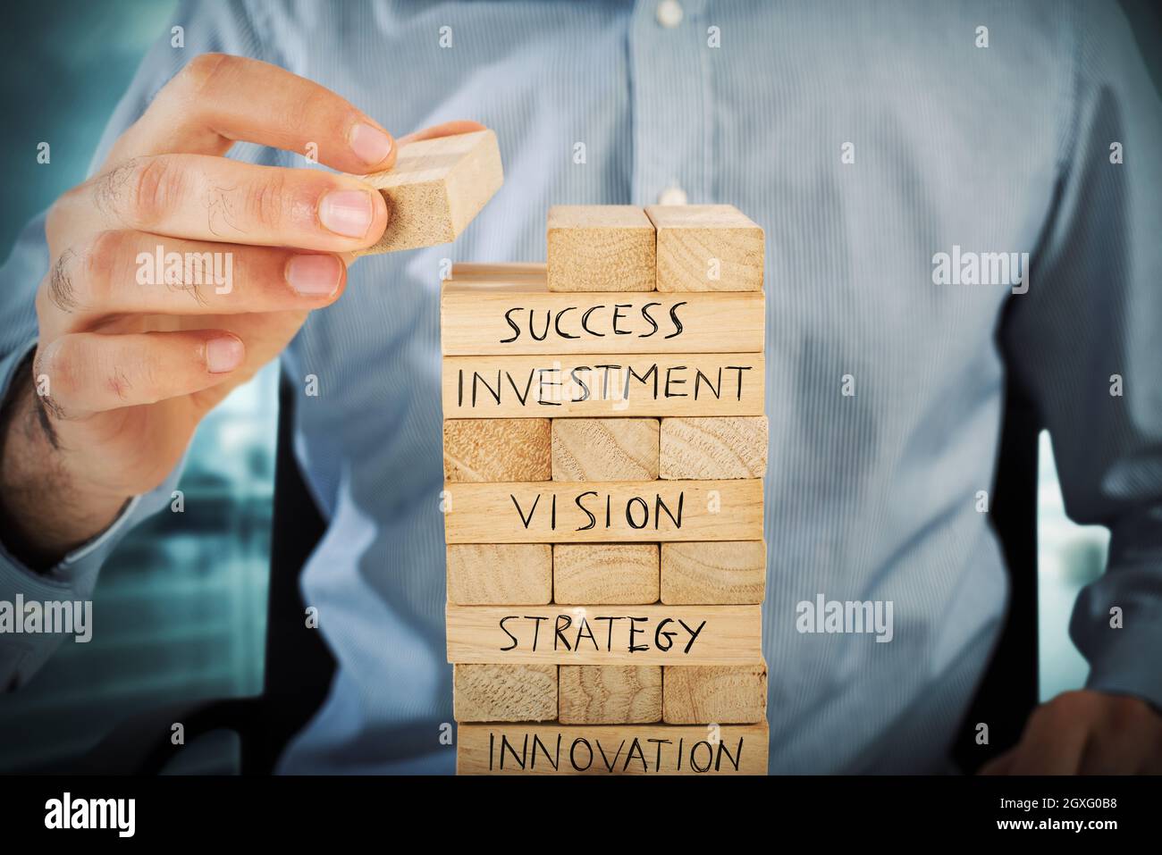 Businessman make a building with wood blocks Stock Photo - Alamy