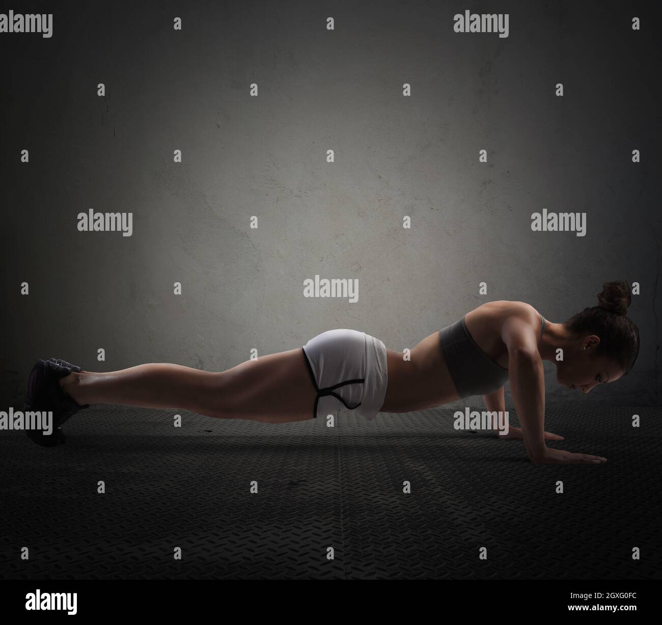 Athletic girl is training doing push up Stock Photo - Alamy