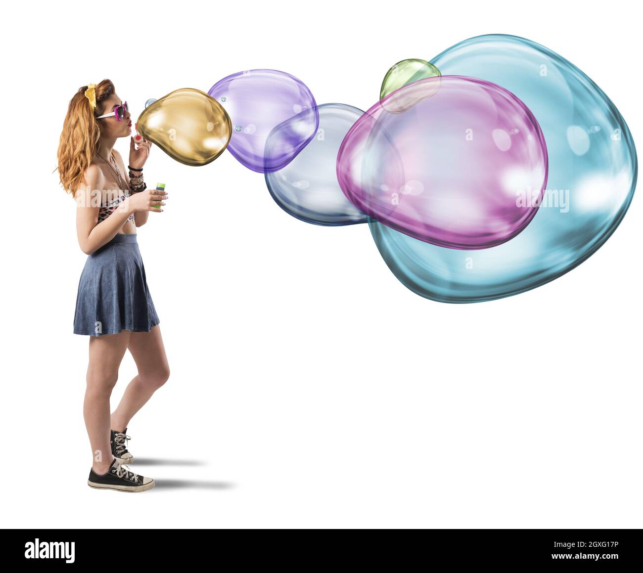 Girl has fun making colorful soap bubbles Stock Photo - Alamy
