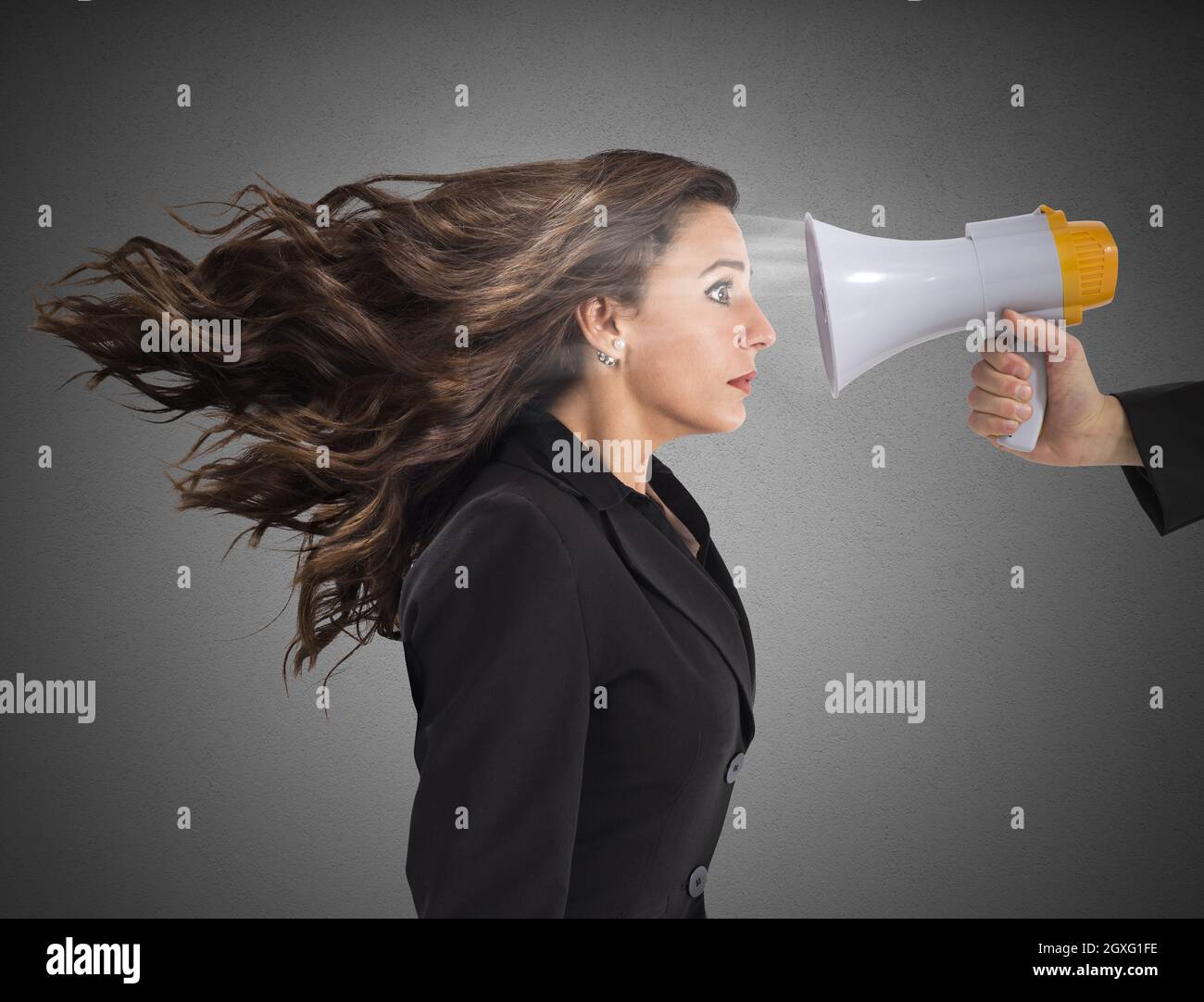 Businesswoman frightened by the megaphone loud noise Stock Photo - Alamy