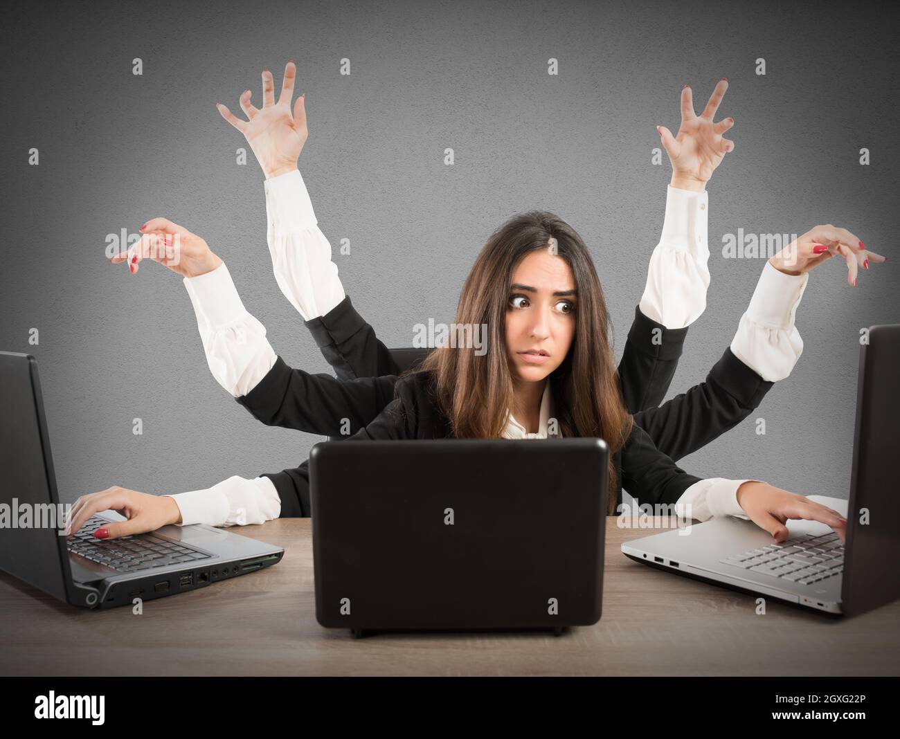 Woman with many arms working with three laptops Stock Photo - Alamy
