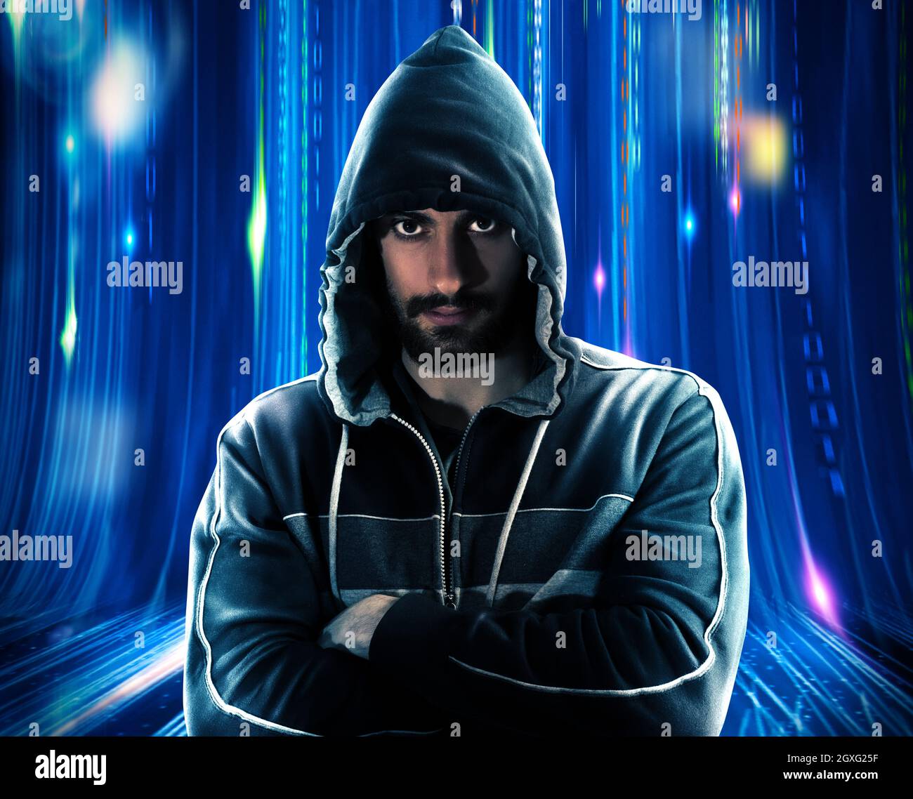 Mysterious man with hoodie and blue lights background Stock Photo - Alamy