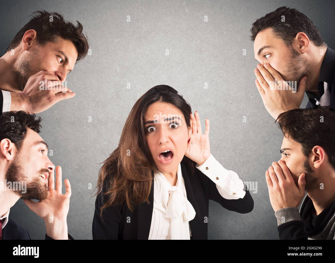 Girl with shocked expression listening to many people Stock Photo - Alamy
