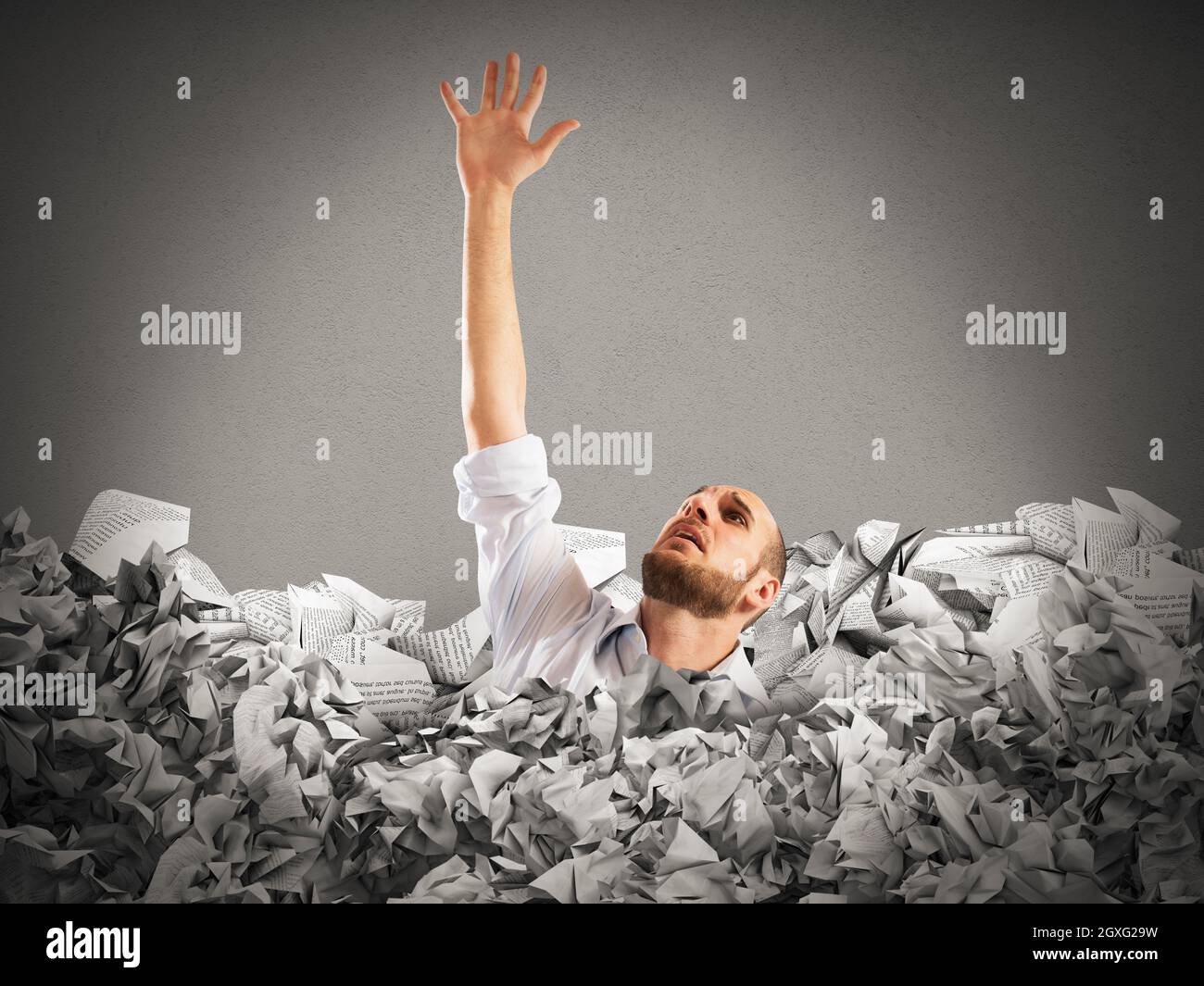 Man asks for help flooded with crumpled paper Stock Photo - Alamy
