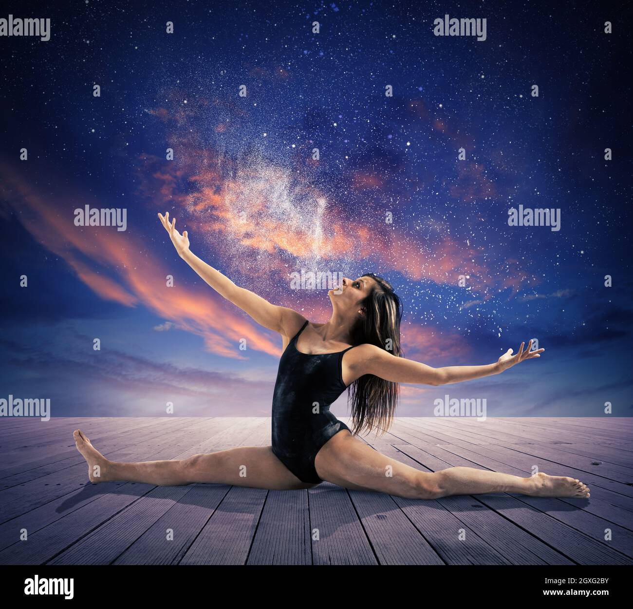 Dancer makes a split under the stars in the sky Stock Photo - Alamy