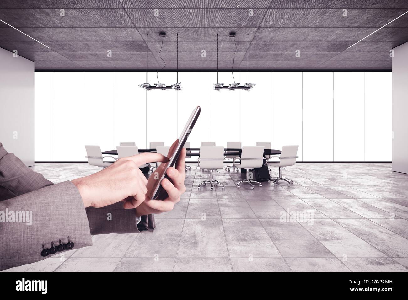 Businessman with cell in a meeting room Stock Photo - Alamy