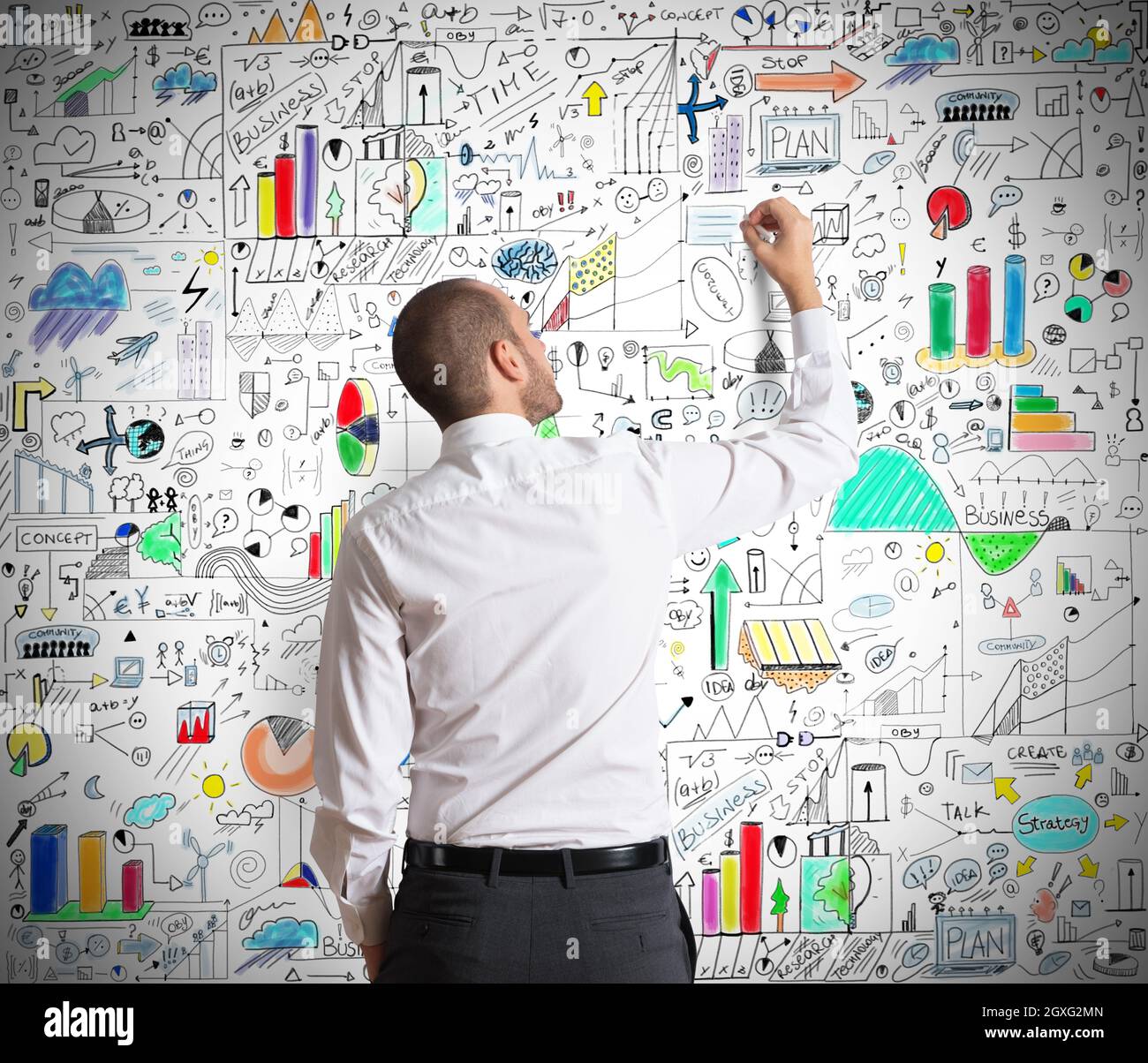 Businessman draws on the wall of business projects Stock Photo - Alamy