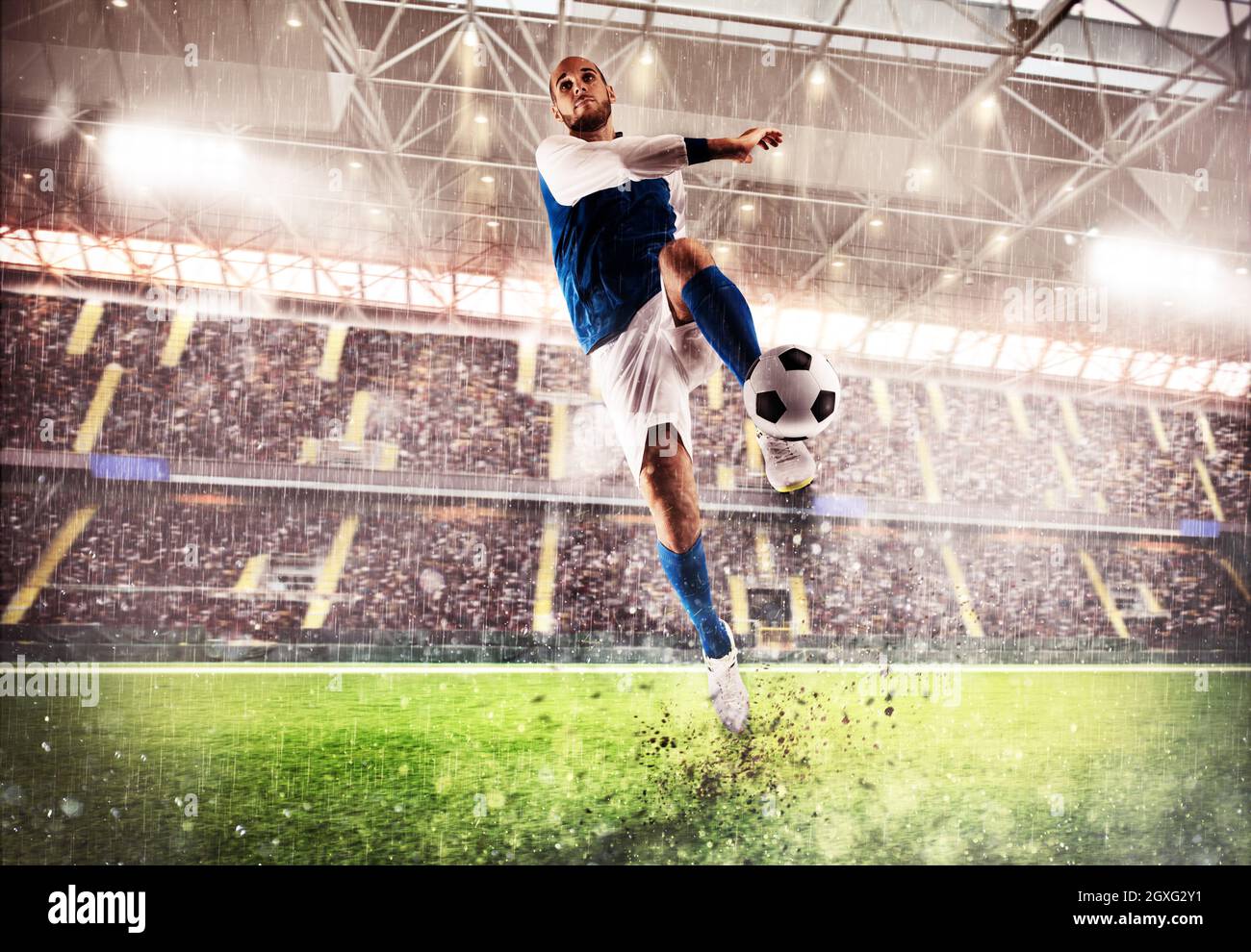 Football player play in a stadium with audience Stock Photo - Alamy