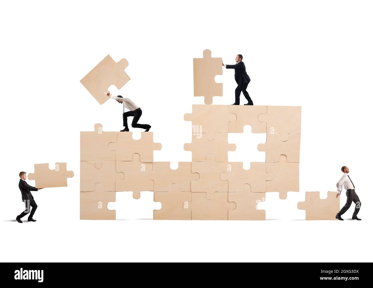 Team of businessmen collaborate and cooperate to build a puzzle Stock ...