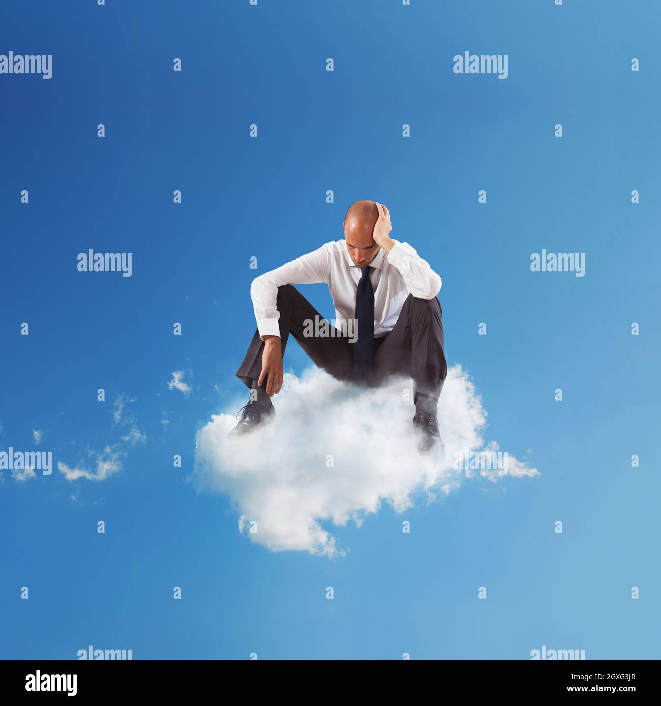 Alone desperate businessman sitting on a cloud in the sky Stock Photo ...