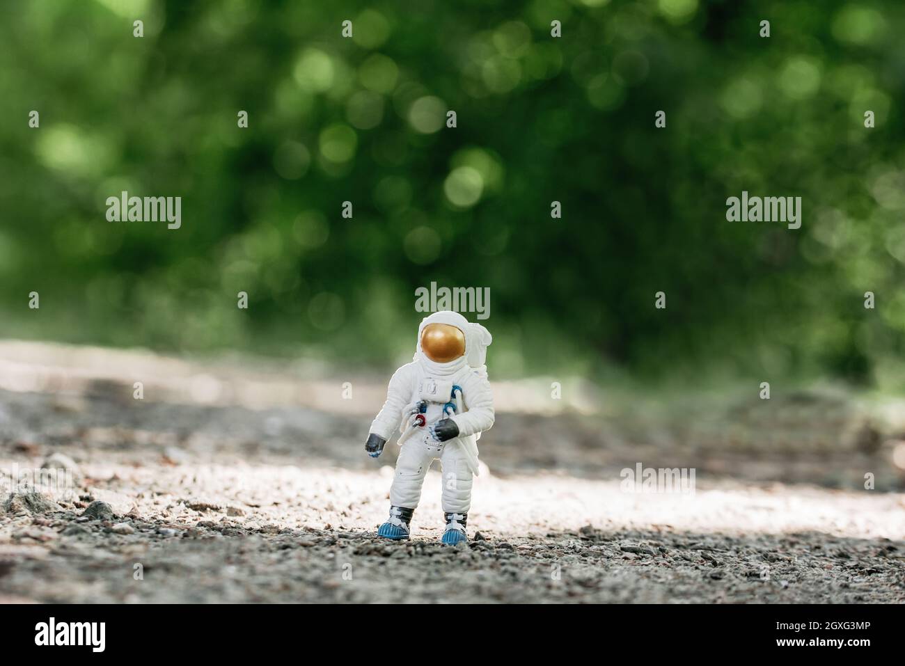toy astronaut standing on ground. Spaceman figure Travel concept ...