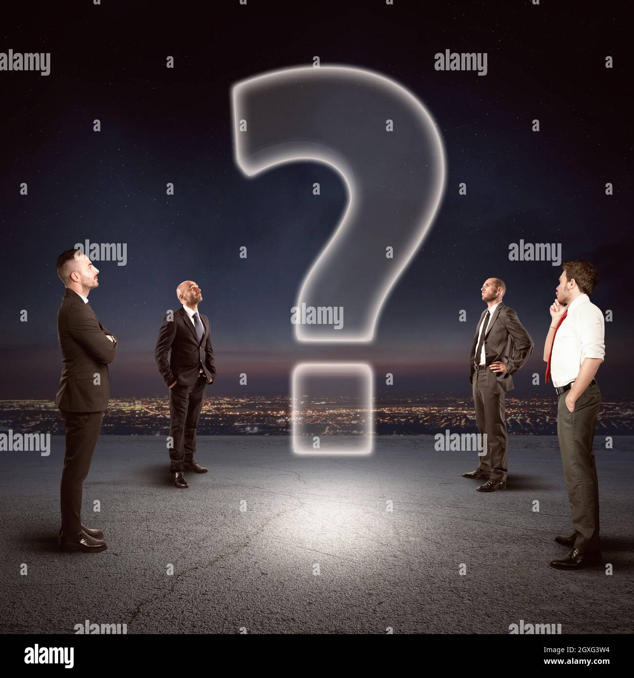 Team of businesspeople watch together a big question mark Stock Photo ...