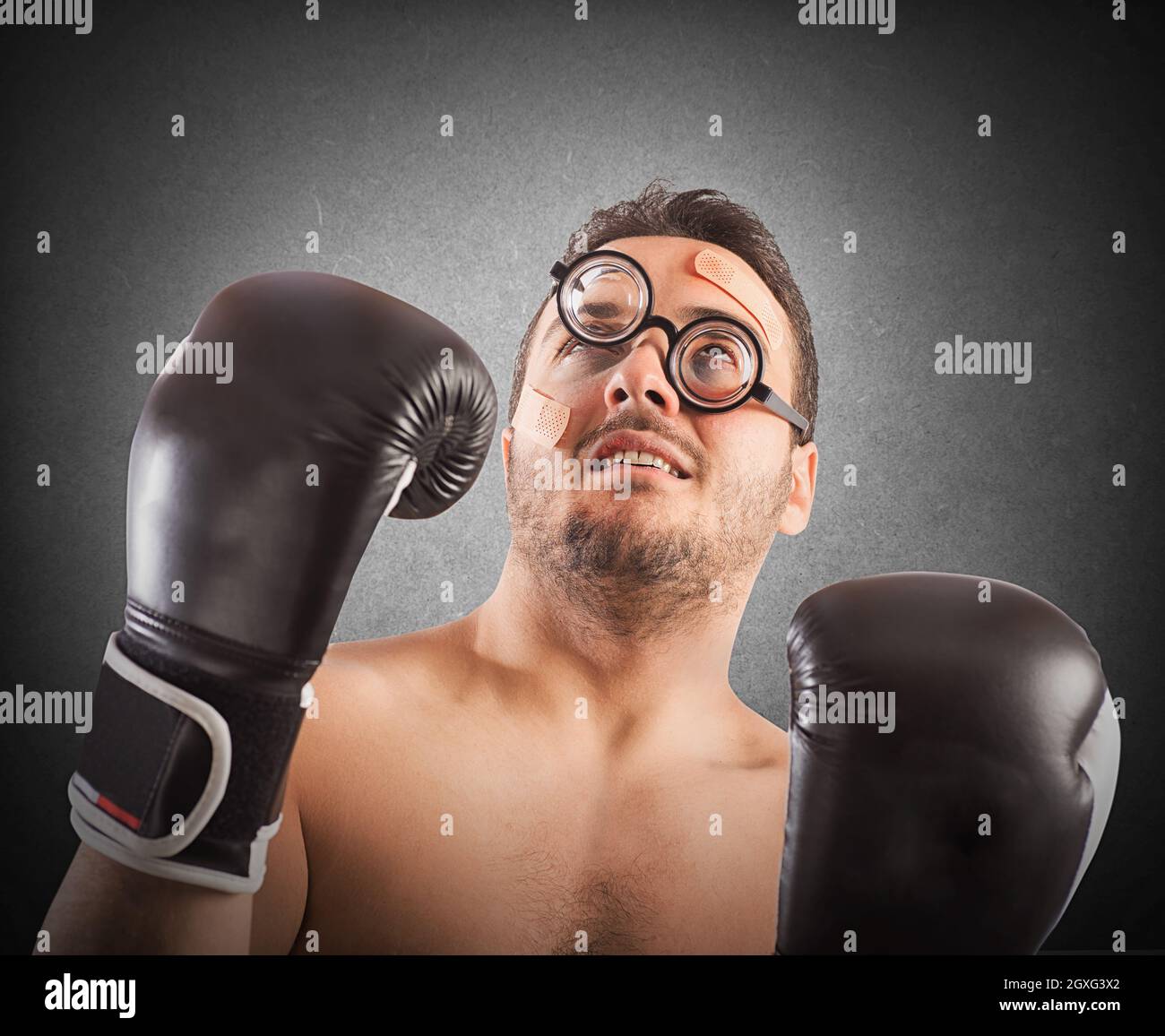 Goofy boxer with nerd eyeglasses and plasters Stock Photo - Alamy