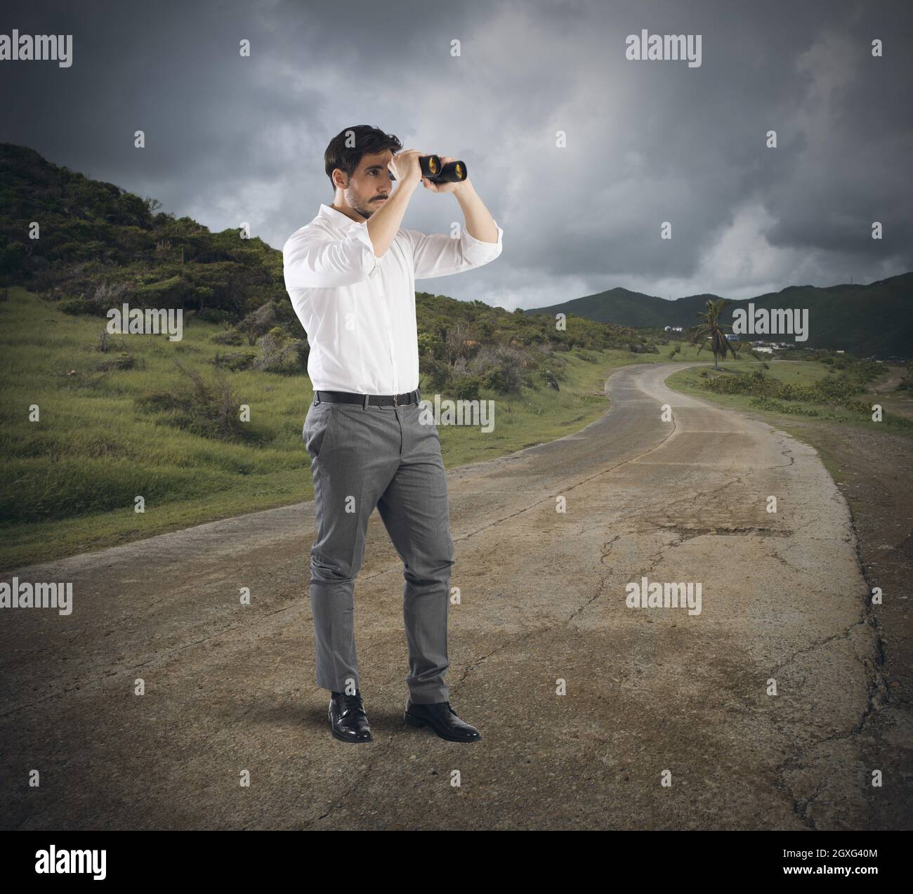 Businessman with binoculars in a mountain path Stock Photo - Alamy