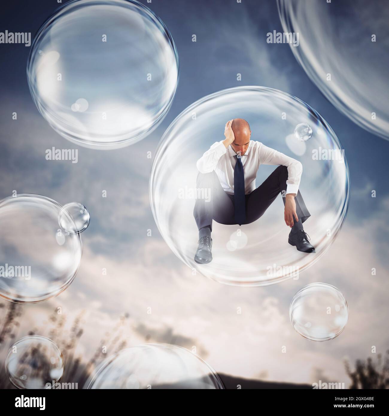 Sad businessman flies in a bubble. isolate themselves inside a bubble ...