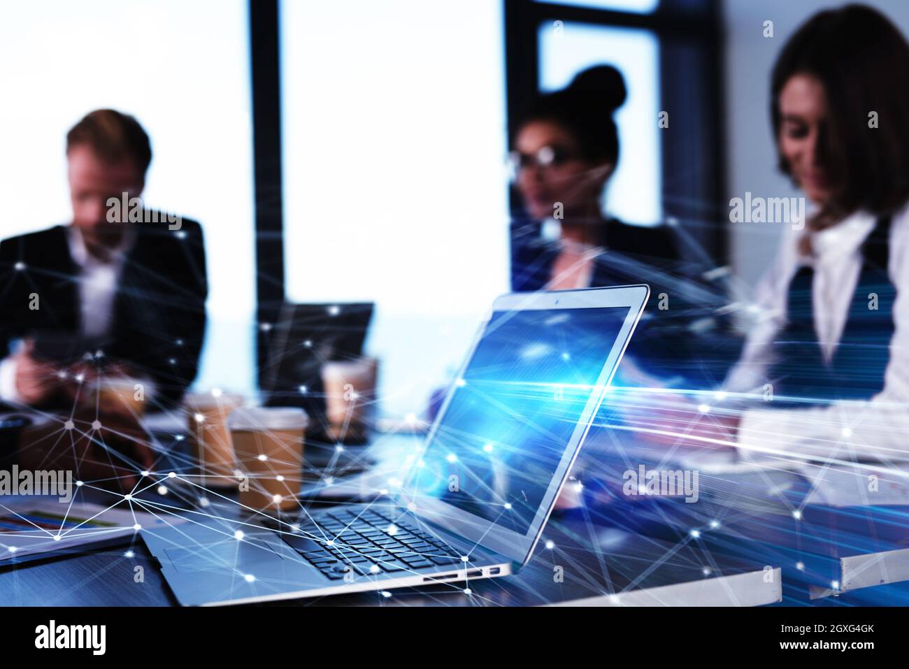 Teamwork works with a laptop in office. Concept of internet sharing and ... Teamwork works with a laptop in office. Concept of internet sharing and ...