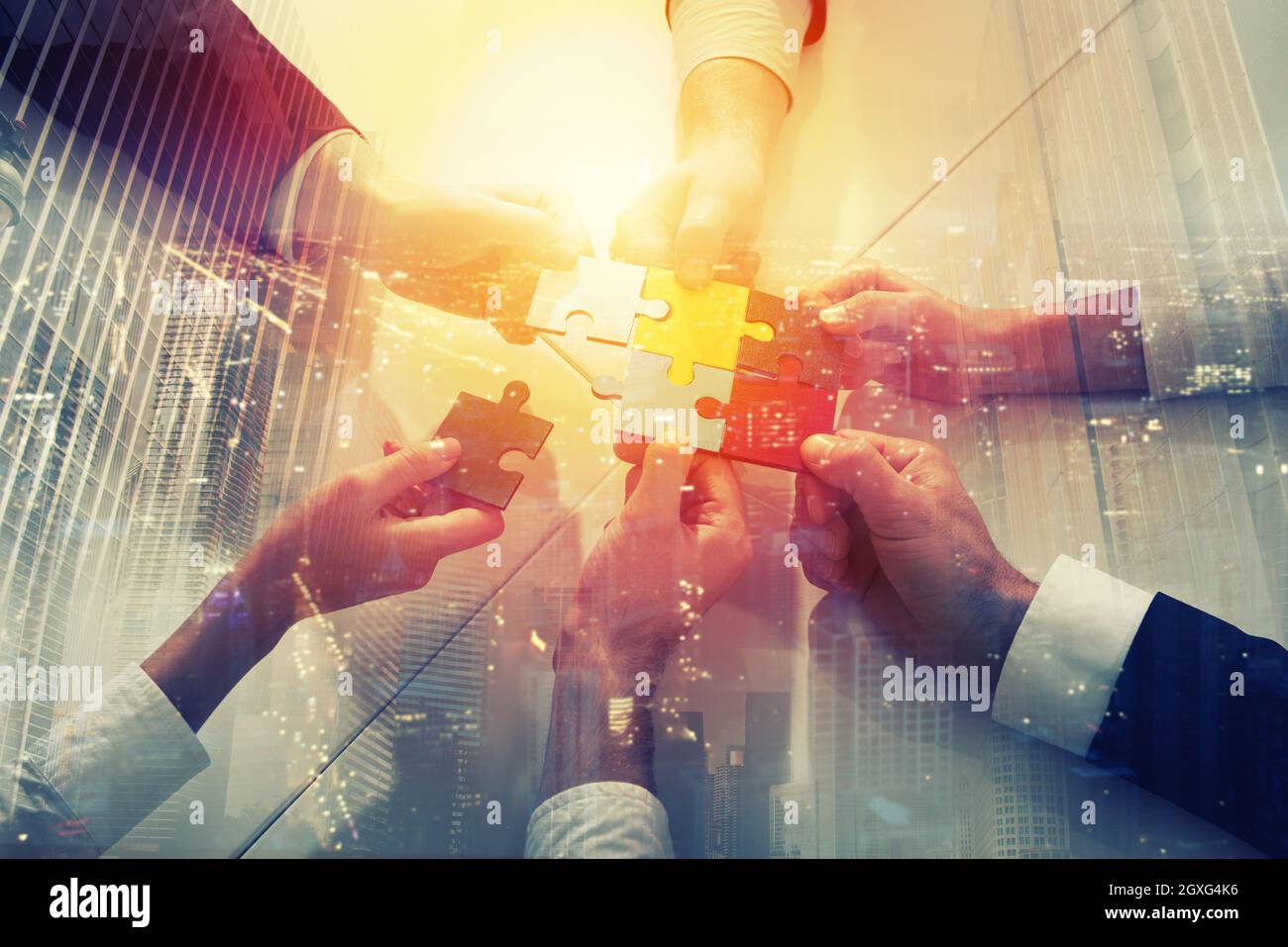 Businessmen working together to build a colored puzzle. Concept of teamwork, partnership ...