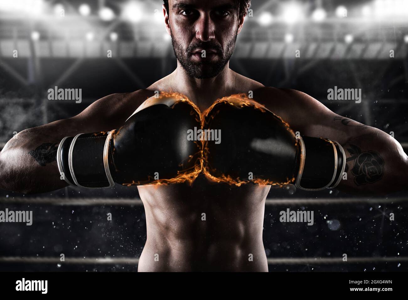 Determined and confident boxer with fiery boxing gloves Stock Photo - Alamy
