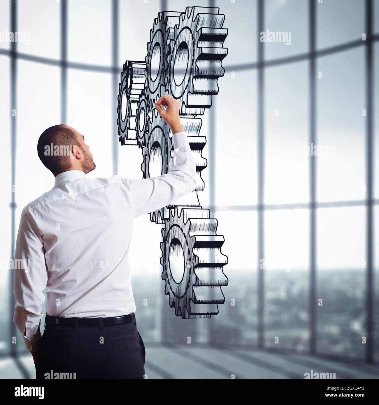 Businessman draws a System of a mechanism gears move together Stock ...