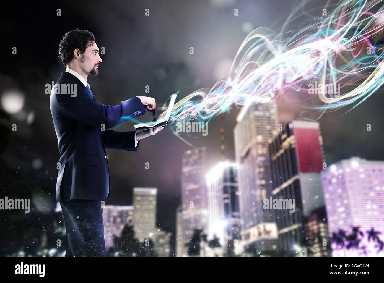 Businessman working with laptop with light effects on the city background. Work with new ...