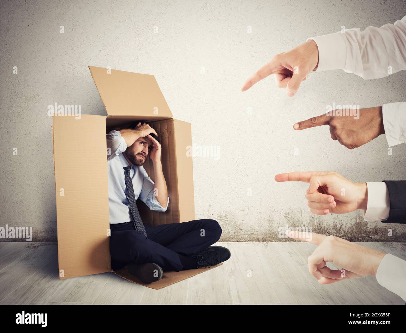 Businessman indicated by colleagues hiding in a cardboard Stock Photo ...