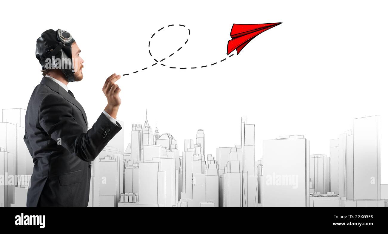 Businessman holding a small paper plane on cityscape background ...