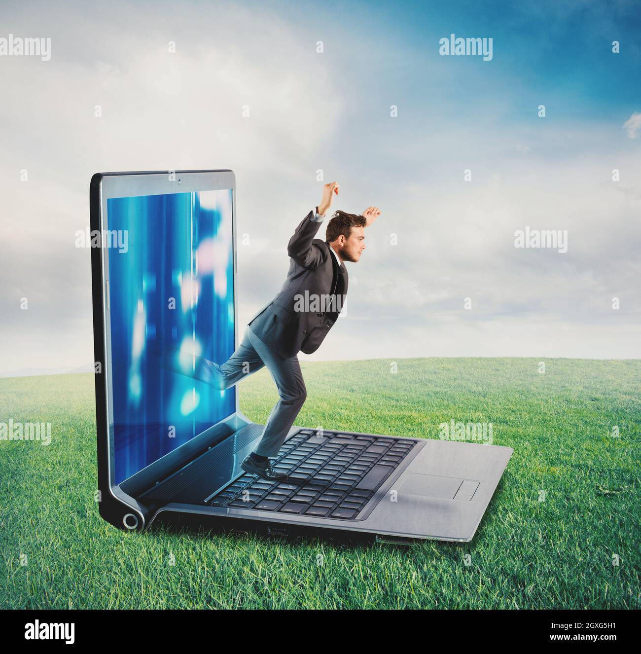 Businessman leaves the screen of a computer to a lawn. Technology ...