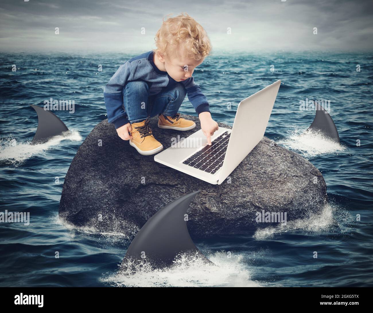 Child looks at the computer on a rock surrounded by sharks Stock Photo ...