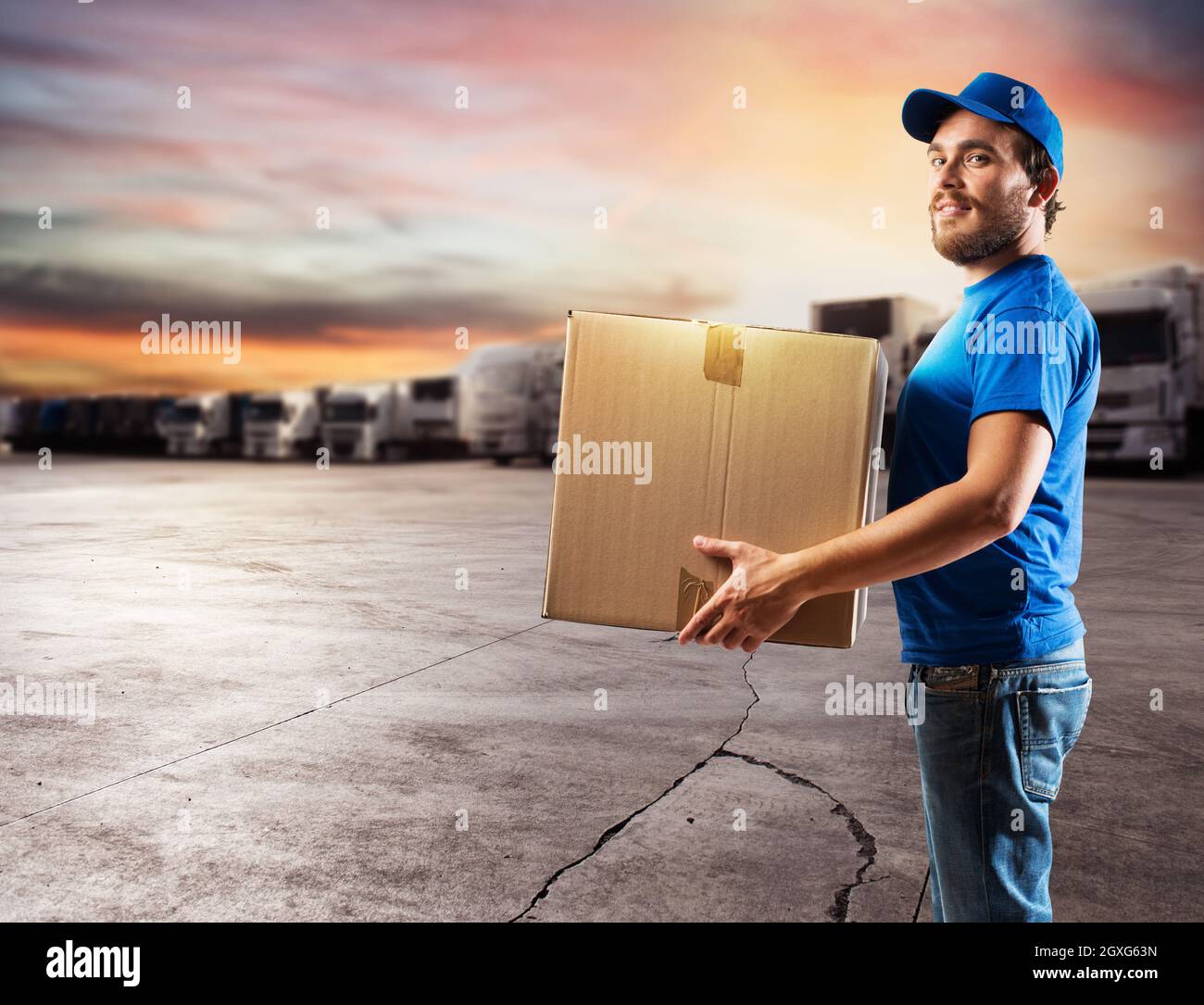 Courier ready to deliver packages with transport truck Stock Photo - Alamy