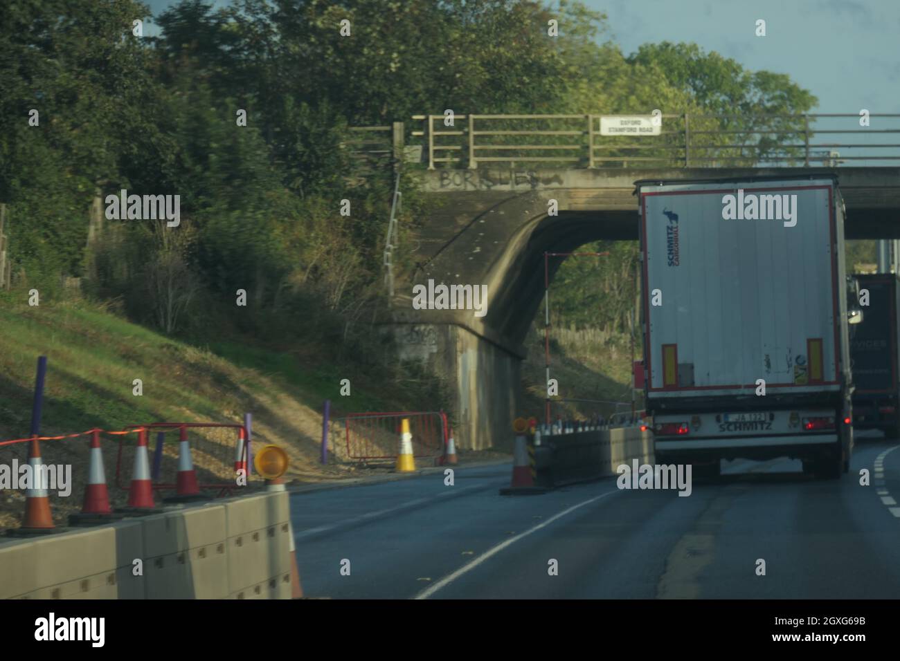 Smart motorway in Northamptonshire UK road bridge lorry over motorway ...