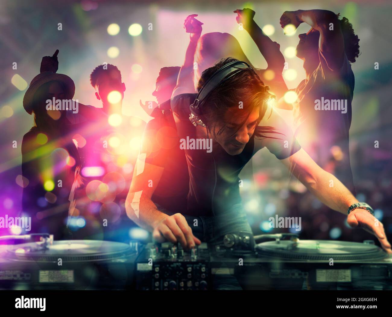 DJ at work playing music with a mixer at the discotheque. Double ...