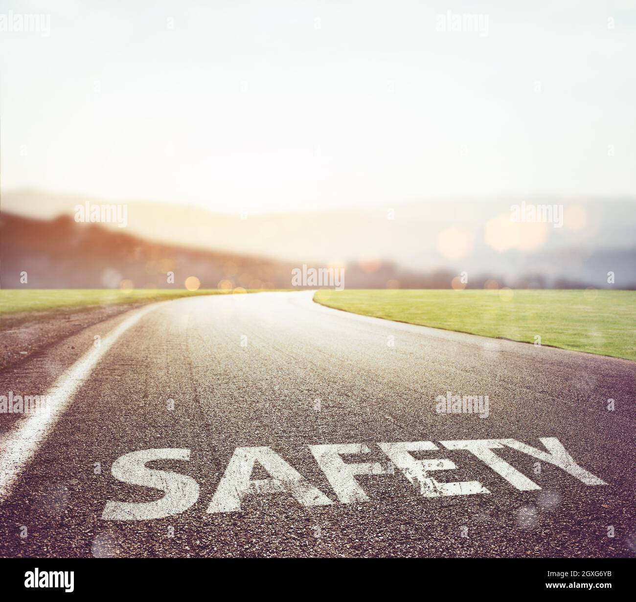 Road with safety writing on the asphalt with sun in front. Concept ...