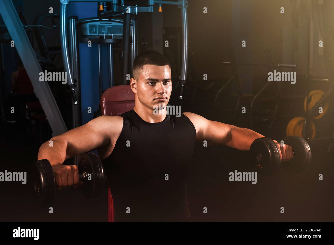 A young guy works out in the gym Stock Photo - Alamy