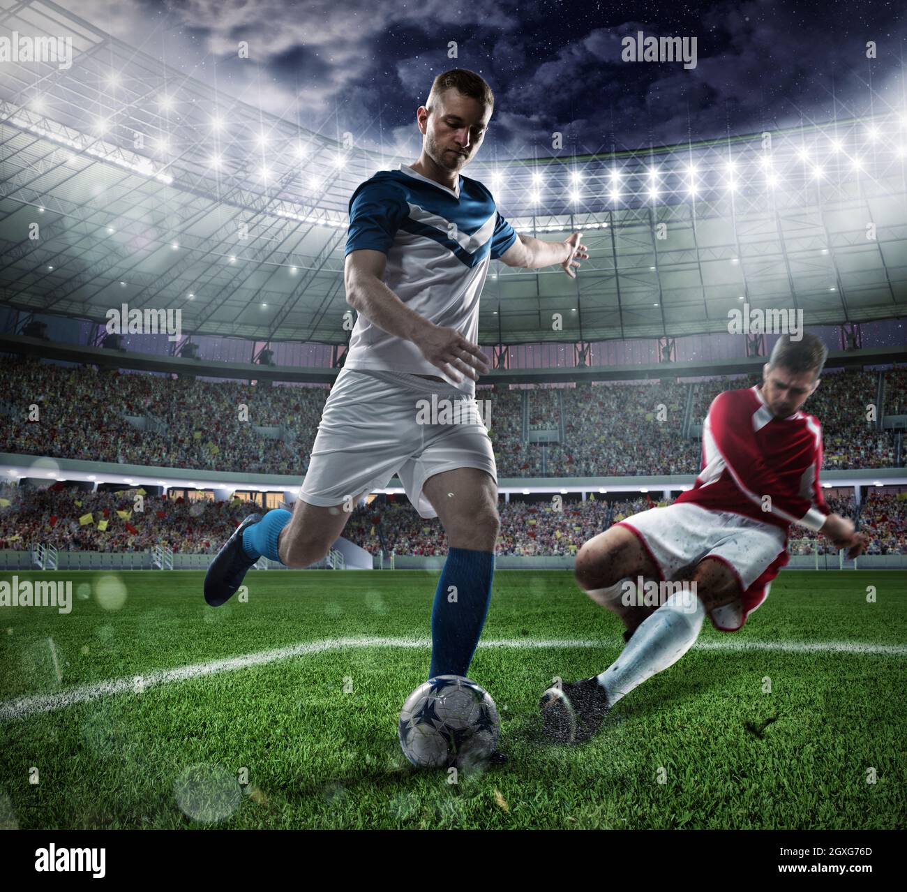 Football action scene with competing football players at the stadium ...