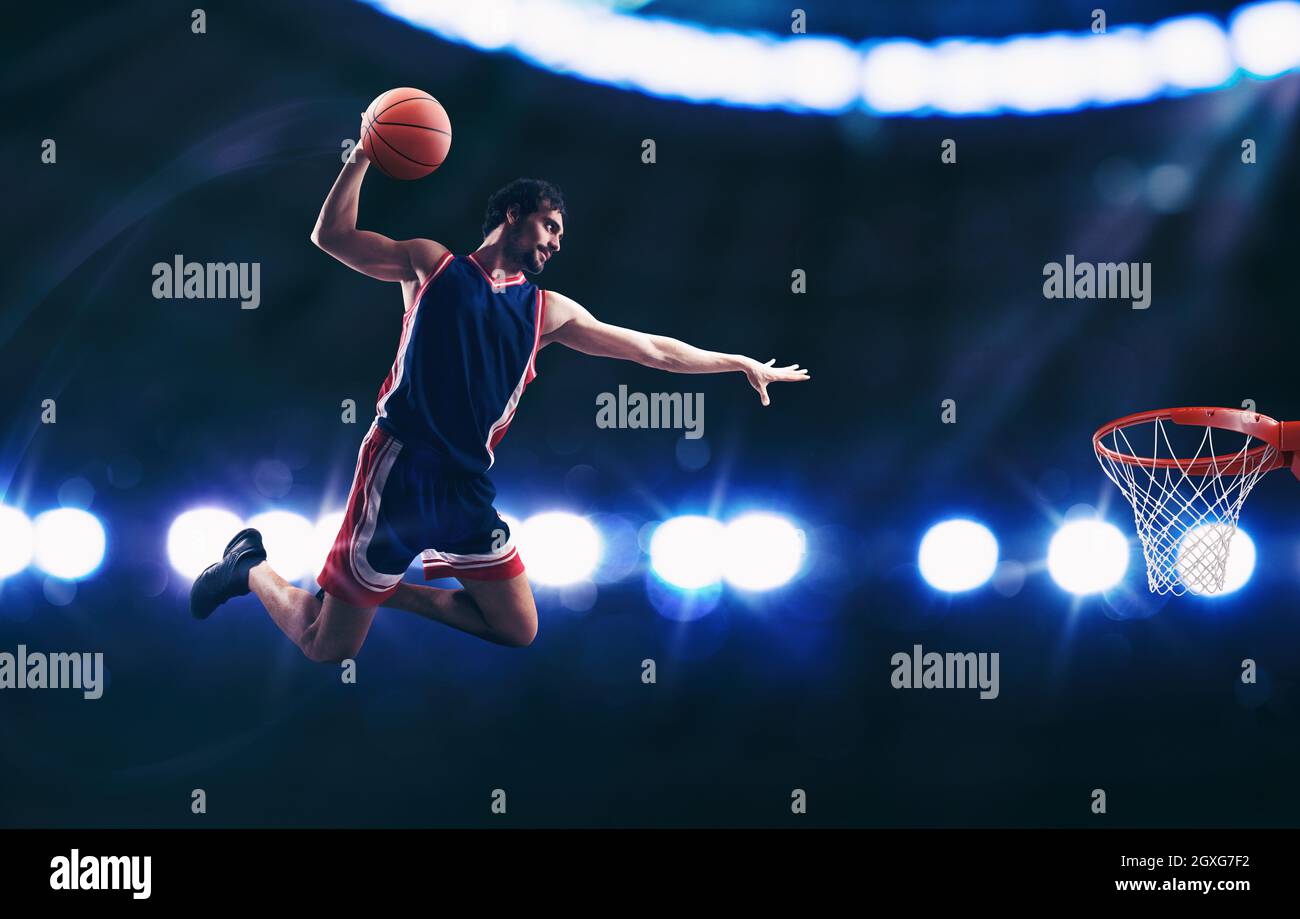 Basketball player slams dunk the ball to the basket Stock Photo - Alamy