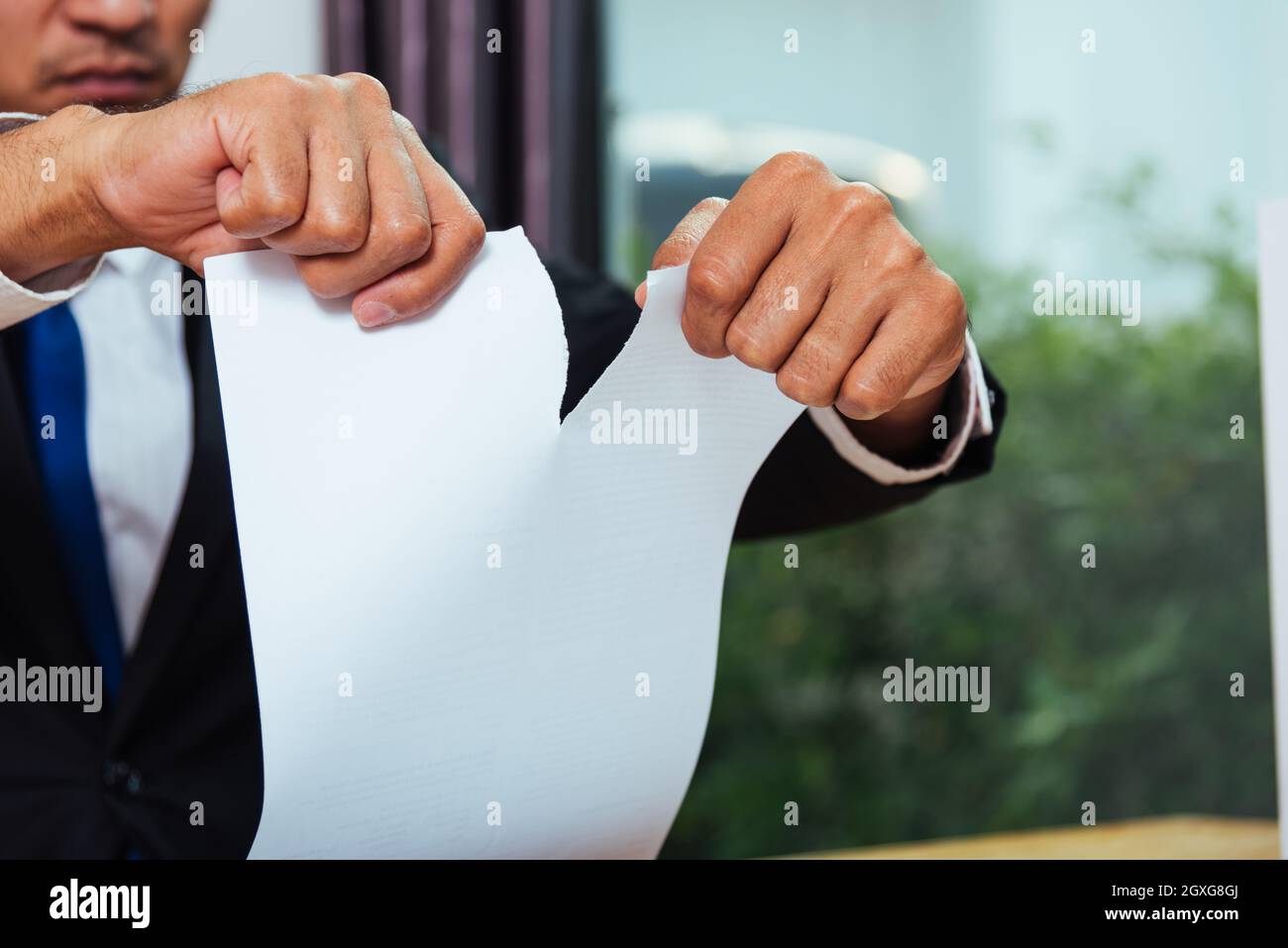 Business man angry tearing paper document on desk office Stock Photo ...