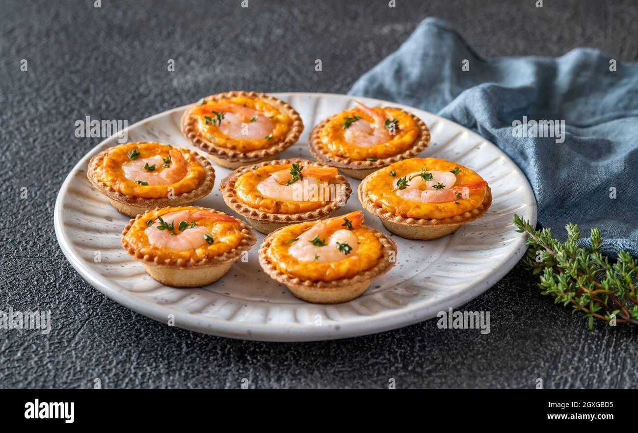 Portion of shrimp tartlets with cheesy sauce Stock Photo - Alamy