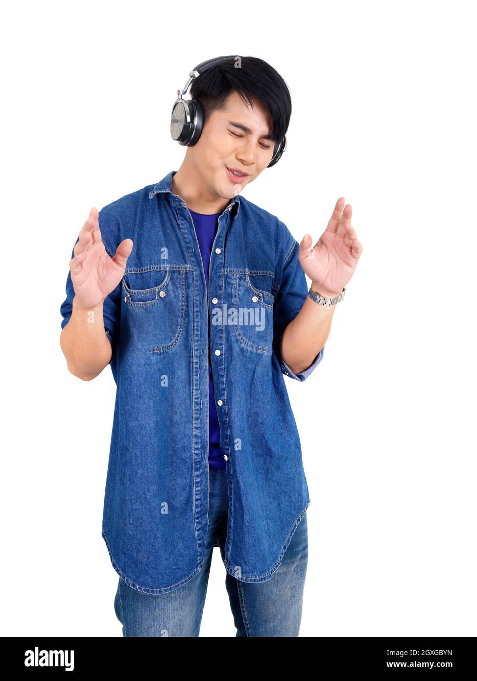 Young asian man dance, swaying, and lifting his arms rhythmically while ...