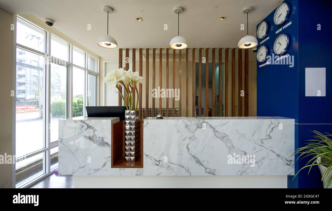 A long white marble reception counter located in the hotel lobby Stock ...