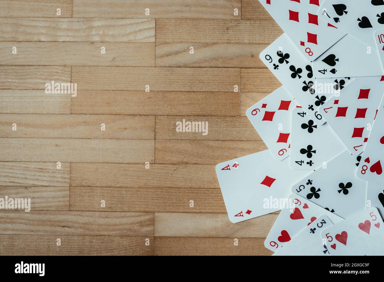 Gaming cards are lying on wood table. Playing cards at home, copy space ...