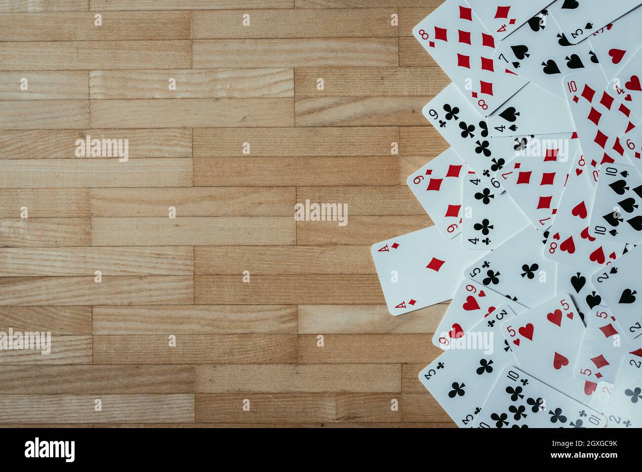 Gaming cards are lying on wood table. Playing cards at home, copy space ...