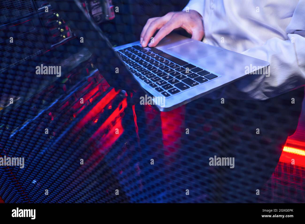 Busy maintenance administrator controlling operational server rack ...