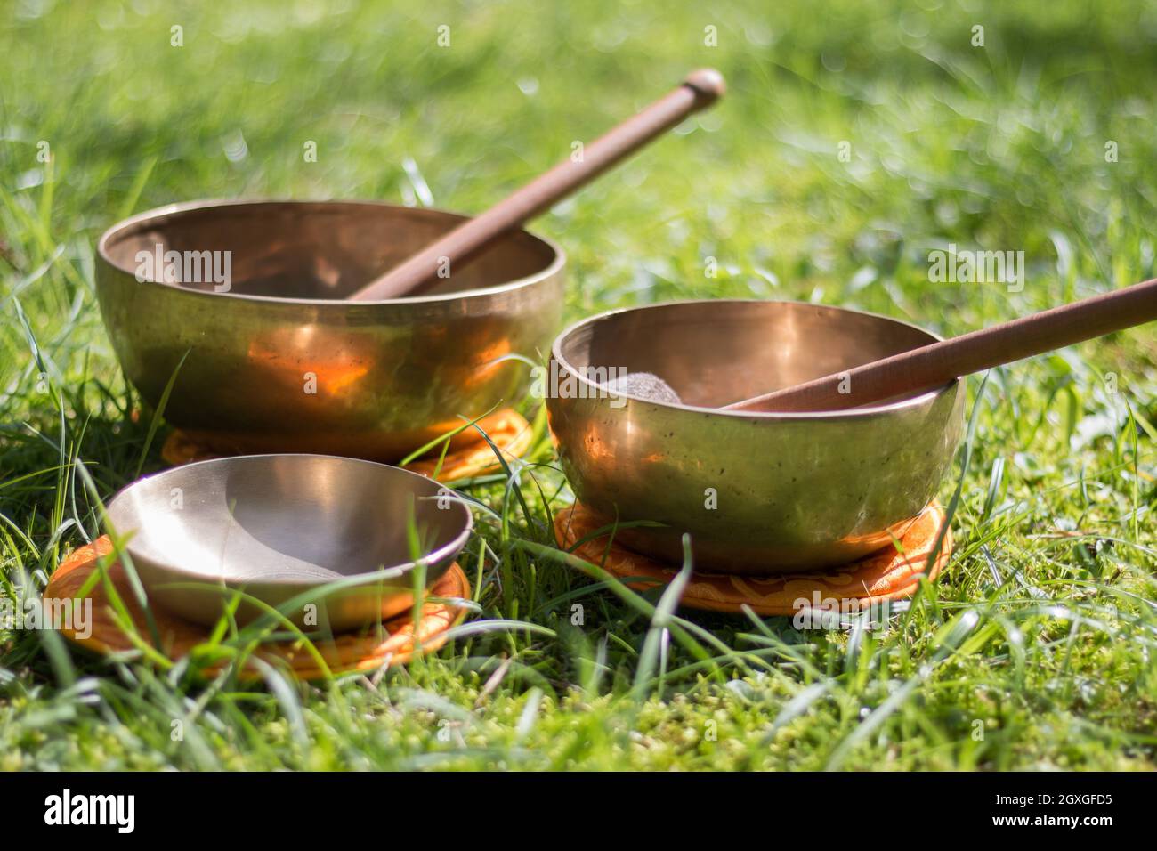 Set of metal singing bowls in the grass of the own garden, zen Stock ...