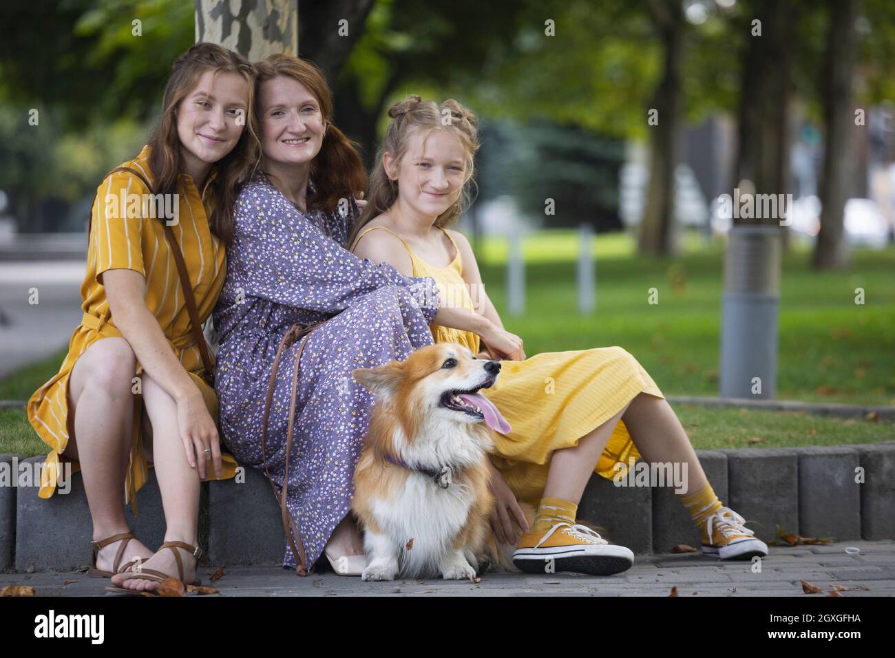 mom with daughters and dog corgi. dog in the family Stock Photo - Alamy