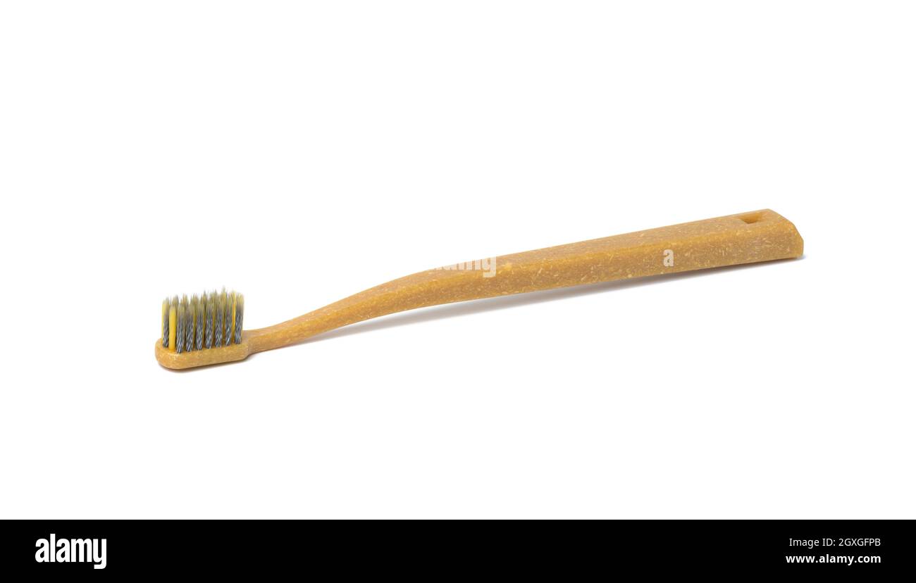 brown plastic toothbrush on white background, hygiene product isolated ...