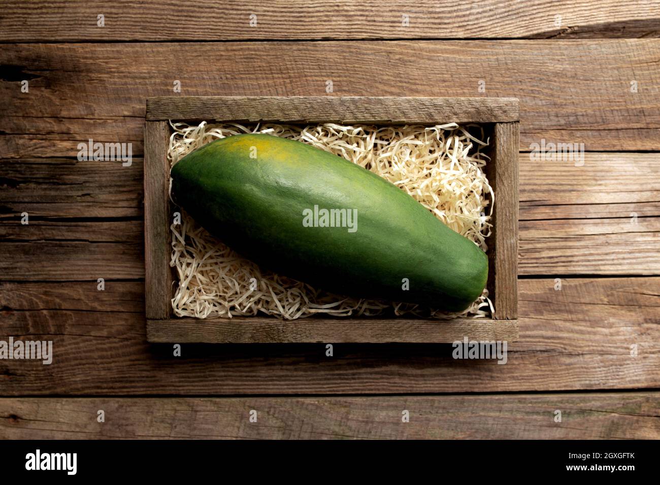 Fresh tropical papaya fruit in a wooden delivery box on a wooden ...