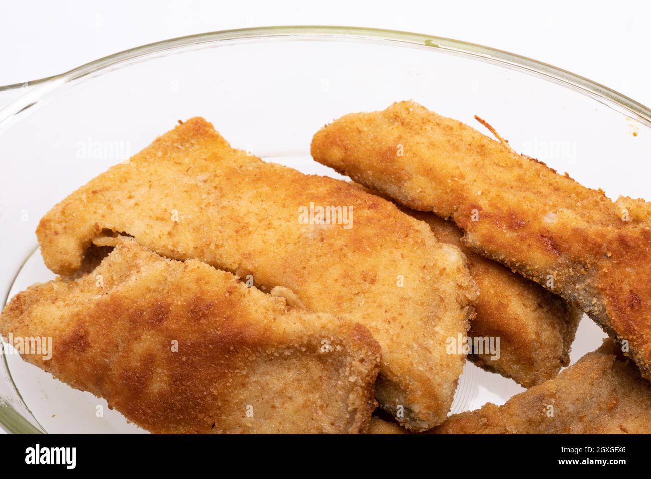 Breaded fish fillets in a glass, heat-resistant dish Stock Photo - Alamy