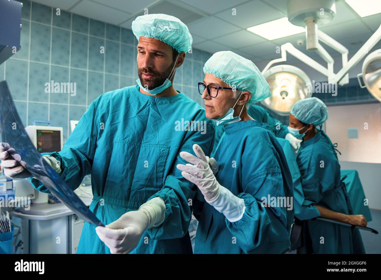 Successful team of surgeon standing in operating room, ready to work on ...