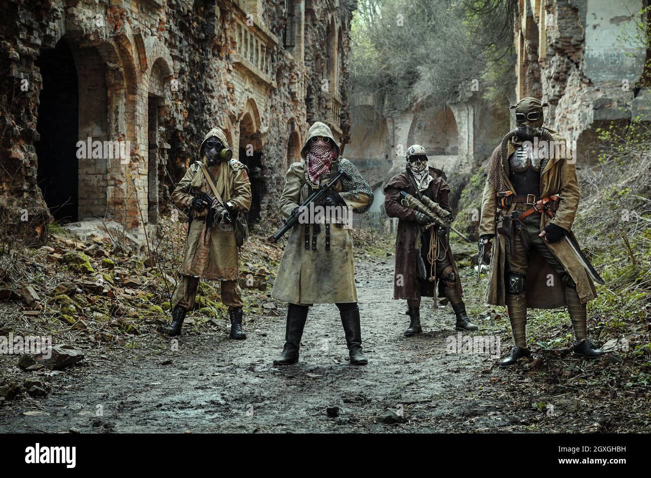 Nuclear post-apocalypse. Survivors in tatters and gas mask on the ruins ...